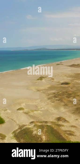 Sandy beach and ocean with waves. Paoay Sand Dunes, Ilocos Norte ...