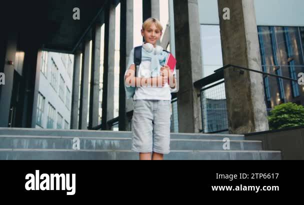Pensive good- looking caucasian schoolboy with backpack and books ...
