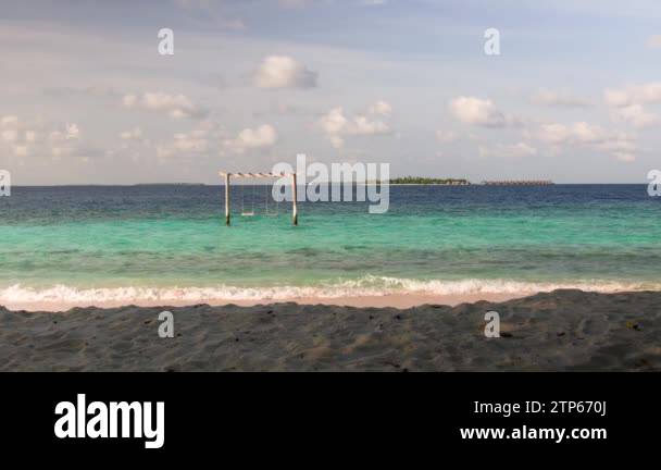 Beach swing and watching ocean waves. Carefree summer moment at ocean ...