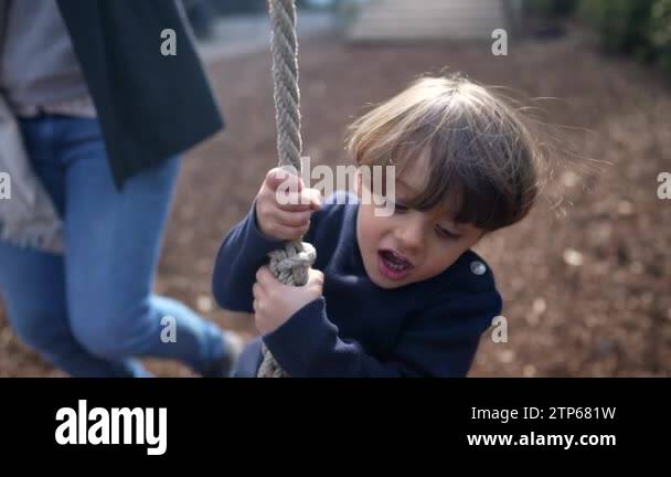 Child Gripping Wire Slide Rope at Public Park During Autumn Season ...