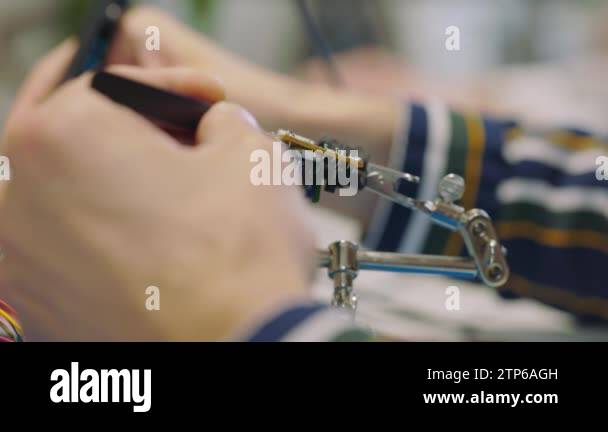 Engineer Soldering a Circuit Board in a High Tech Research Laboratory ...