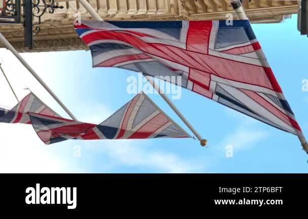 Close vertical view of flags of the United Kingdom located on facade of ...
