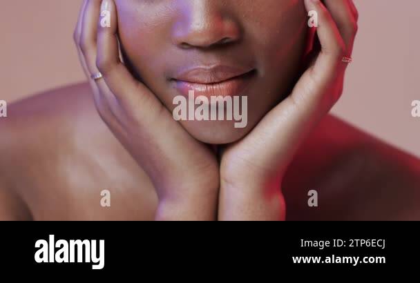 African american woman with short dark hair in blue and pink light ...