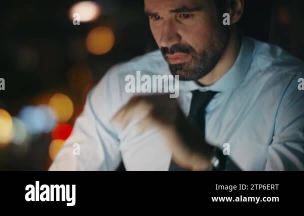 Overwhelmed entrepreneur working late evening at dark workplace close ...