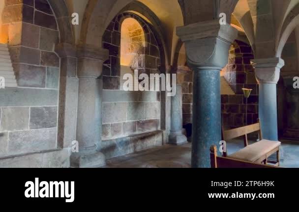 The interior of a church with a vaulted wooden ceiling and beams. The ...