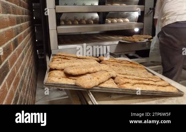 Craft mini-bakery producing French pastries. The baker takes freshly ...