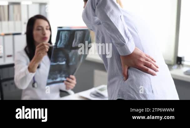 Doctor surgeon medical examination of patient with pain in back and ...