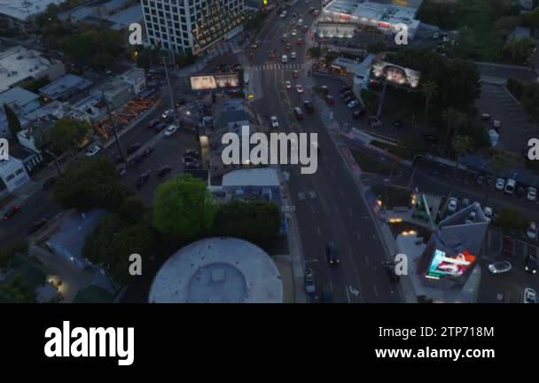 High angle view of traffic in evening streets of metropolis. Tilt up ...