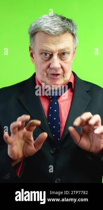 Senior newscaster journalist or speaker presenting news. Local newsreader speaks in TV studio ...