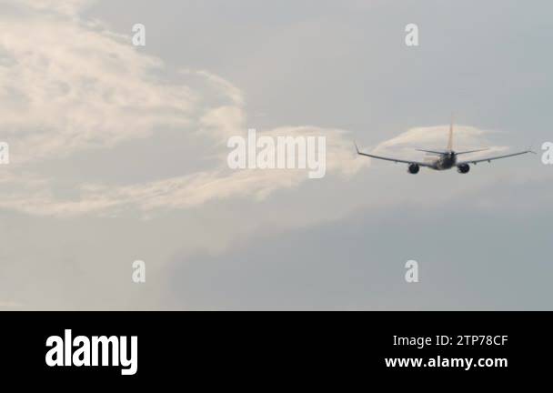 Jet Airplane with an unrecognizable livery gains altitude after takeoff ...