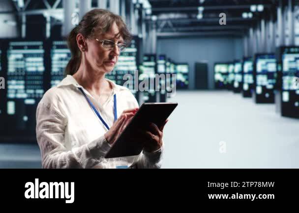 Senescent admin working in data center housing GPU dedicated server ...