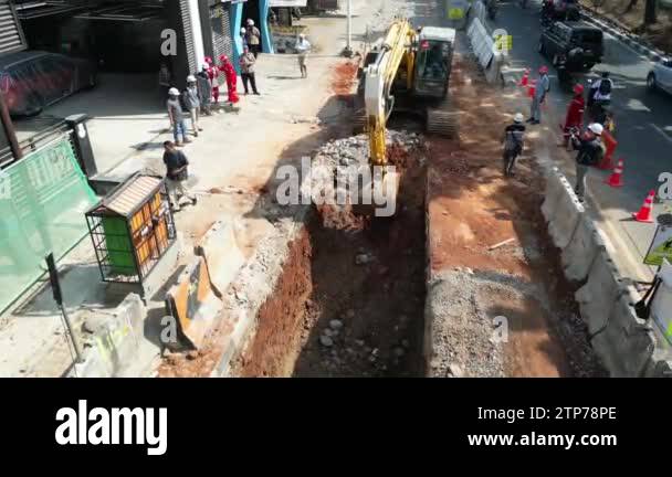 construction of a water channel project on the side of the road using an excavator Stock Video ...