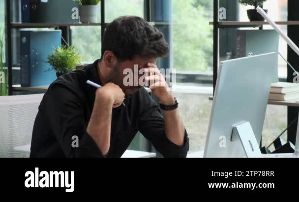 Exhausted Middle Eastern manager, visibly fatigued, grapples with a ...