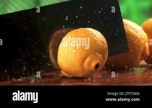 The lemon is cut into two halves. Filmed on a high-speed camera at 1000 ...
