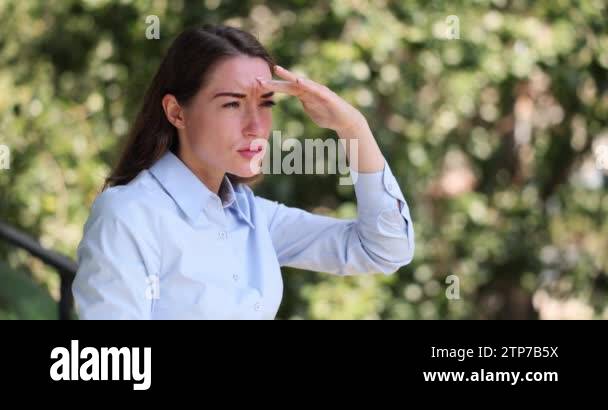 Focused woman looks carefully from balcony. Observation from afar Stock ...
