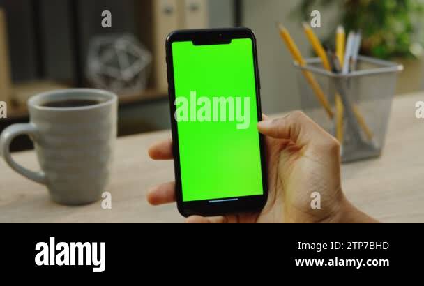 Black smart phone in caucasian mans hands vertically. Fingers scrolling ...