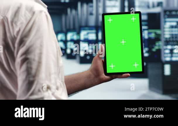 Elderly repairman in data center using mockup tablet to monitor energy ... Elderly repairman in data center using mockup tablet to monitor energy ...