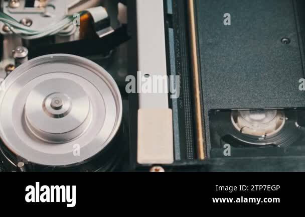 VHS video tape putting inside a VCR recorder and plays. Vintage VHS ...