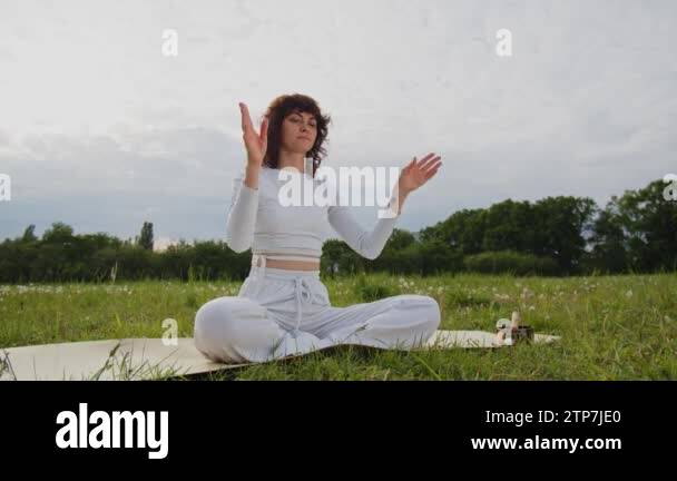 Woman focused on chakra accumulation using hands movement. Sportswoman ...