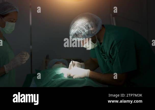 A surgeon diagnosing and identifying an elderly woman's heart problem ...