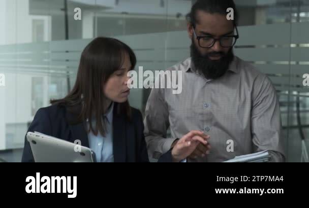 Moment of camaraderie as office workers engage in conversation while ...