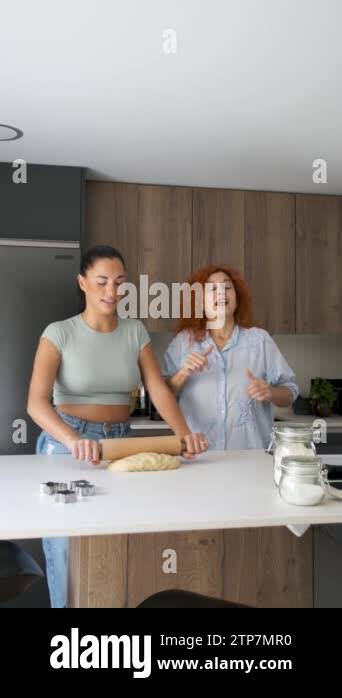 Mother and daughter explaining butter cookies recipe with sign language ...