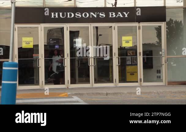 hudsons bay department store front entrance doors with customers people exiting entering store ...