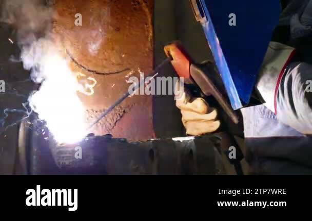 Welding in the metal industry / Worker welder performs arc-welding ...