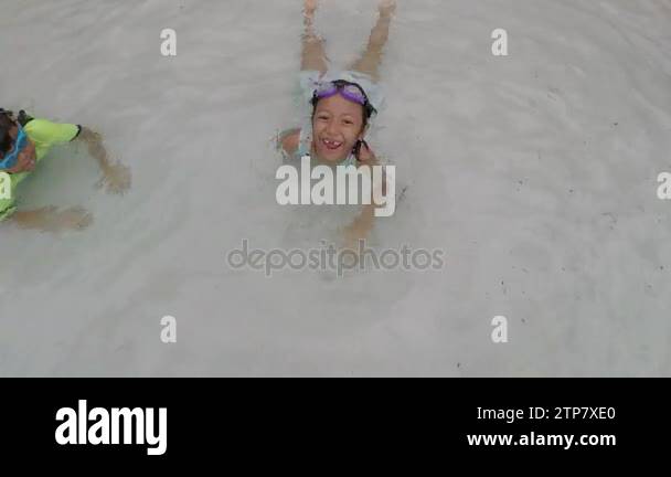 Video footage of a toothless little girl and her brother swimming ...