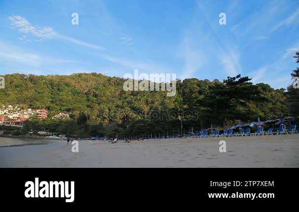 Nai Harn beach on Phuket island. Rows of sun loungers on sand. View on ...
