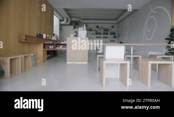 Modern coffee shop with stylish interior, wooden tables with seats and ...