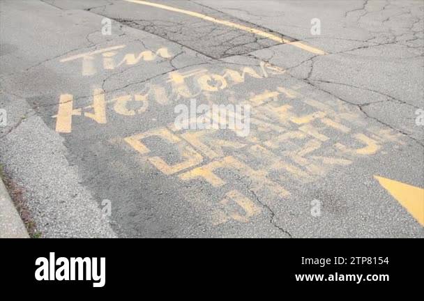 tim hortons drive thru written text caption on pavement in yellow with ...
