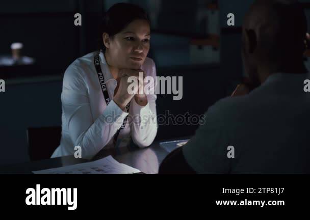 4K Female police detective questioning a crime suspect and showing him ...