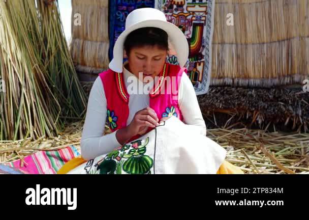 Young Latin American peruvian woman wearing traditional clothes weaving ...