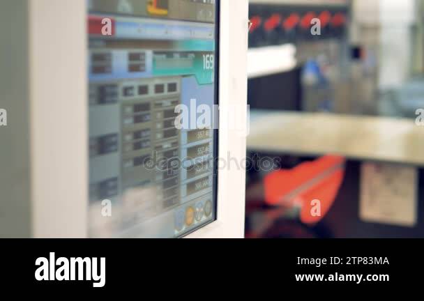 A factory operator changes settings on a press brake screen Stock Video ...