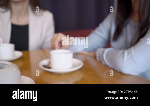 Two women are talking over cup of coffee in restaurant Stock Video ...