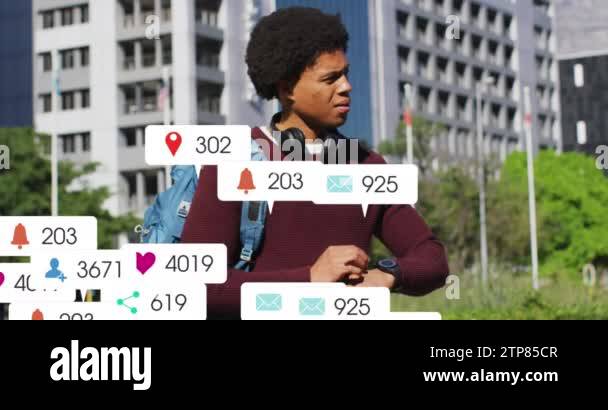 Animation of changing numbers, icons over biracial man standing and looking at smartwatch ...