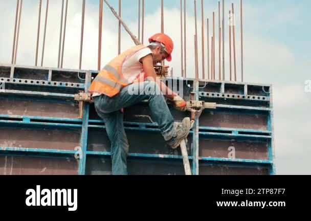 An engineer installs metal structures during the construction of a ...