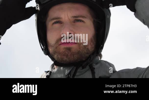Man face detail with helmet putting sun mask preparing for skiing ...