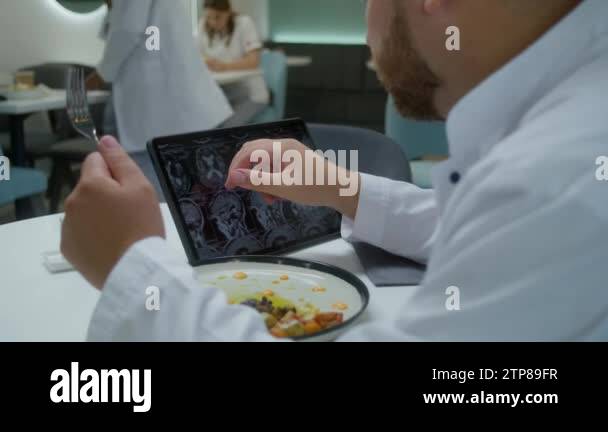 Professional doctor watches image of MRI or CT scan using digital ...