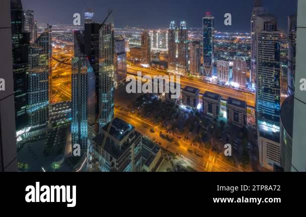 High-rise buildings on Sheikh Zayed Road in Dubai aerial night to day ...
