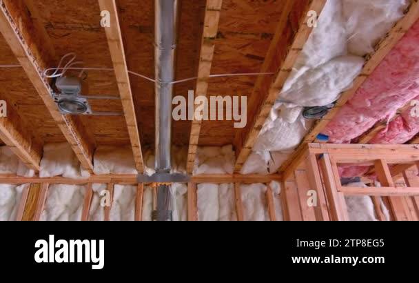 Worker installs hvac system, electrical wires, ceiling light ...