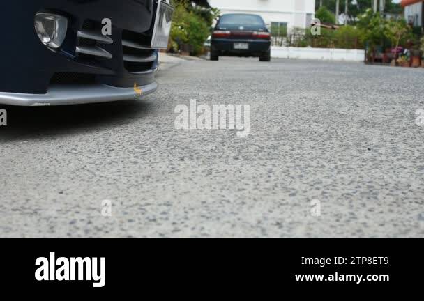 Driving a lowered car on a sloping car park Stock Video Footage - Alamy