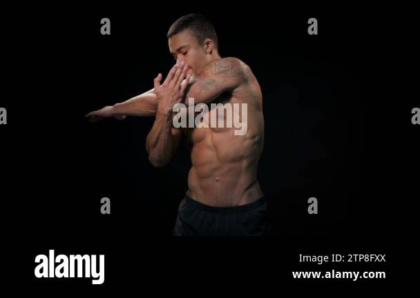 Very muscular handsome athletic man stretches his hands. Muscular man ...