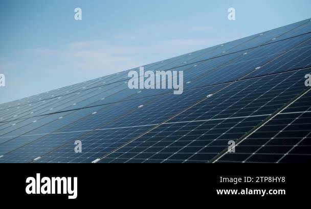 Surface of solar panels in daytime. Handheld shot of modern photovoltaic panels illuminated with ...