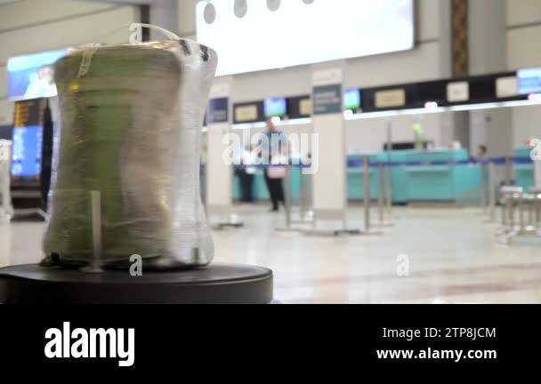 Wrapping luggage baggage bag at the airport terminal for security ...