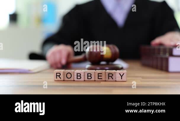 Word Robbery made of wooden cubes against judge knocking with gavel on ...