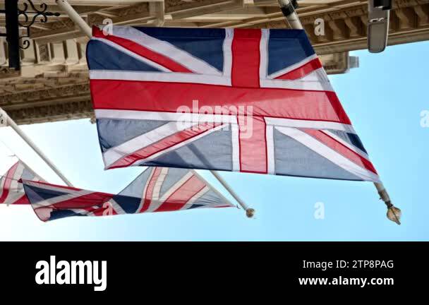 Close vertical view of flags of the United Kingdom located on facade of ...