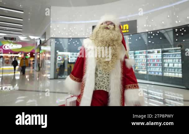Santa Claus brings children a gift to leave under the Christmas tree ...