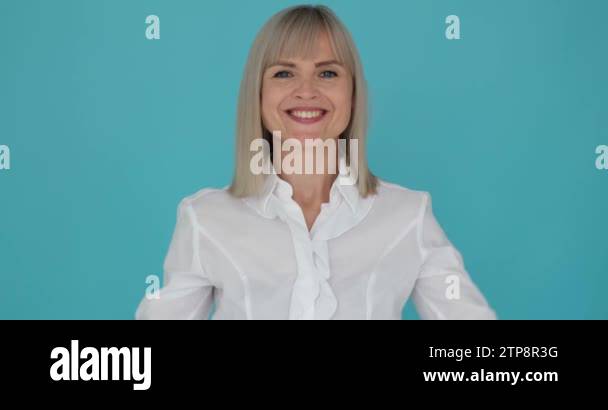 Successful Caucasian woman confidently showing a thumbs-up gesture on a ...